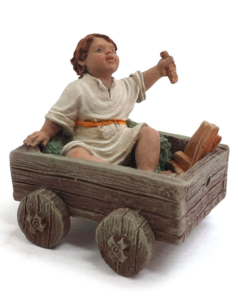 Baby Jesus playing in the wagon